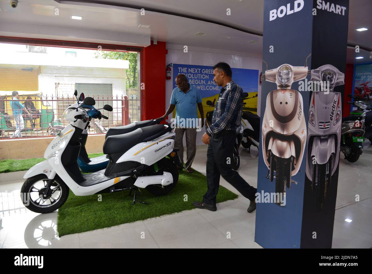 A salesman attends to a costumer at the Hero Electric Showroom. Hero ...