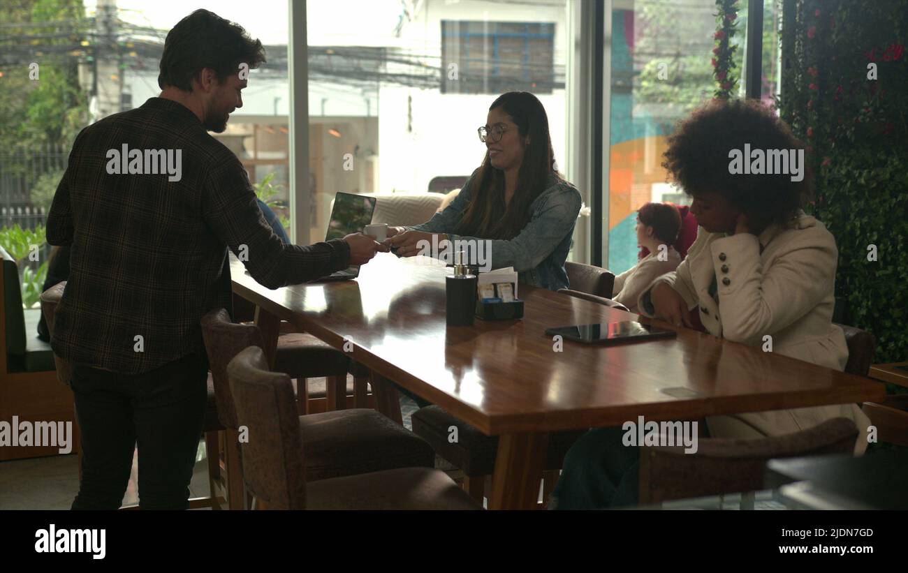 Male customer picking cups of expressos at coffee shop counter and ...