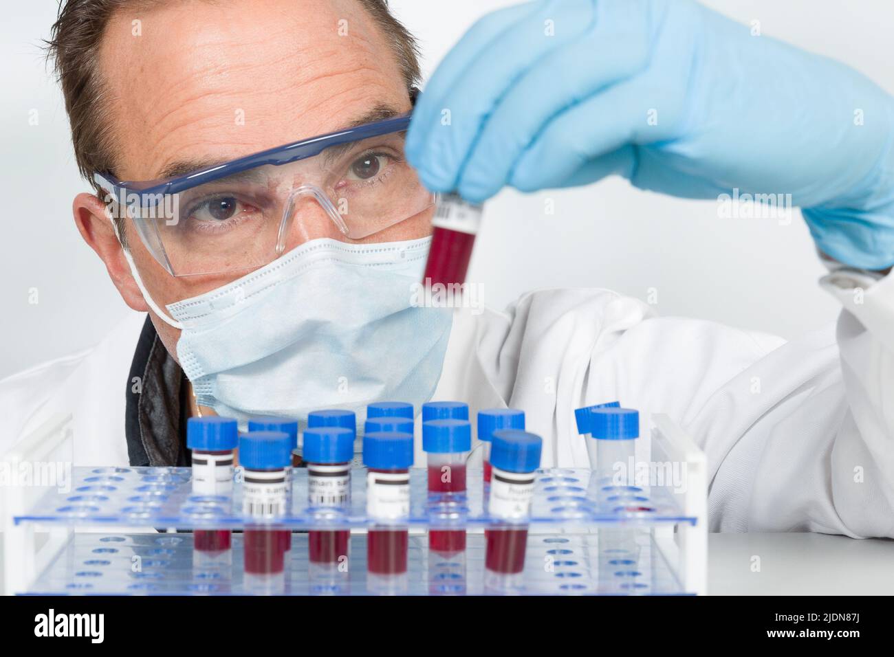 close-up of a scientist working with blood test tubes in a laboratory ...