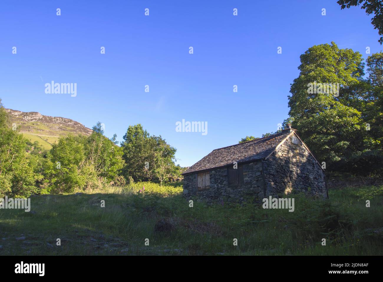 A small stone building on a hill in the Lake District in Cumbria, UK ...