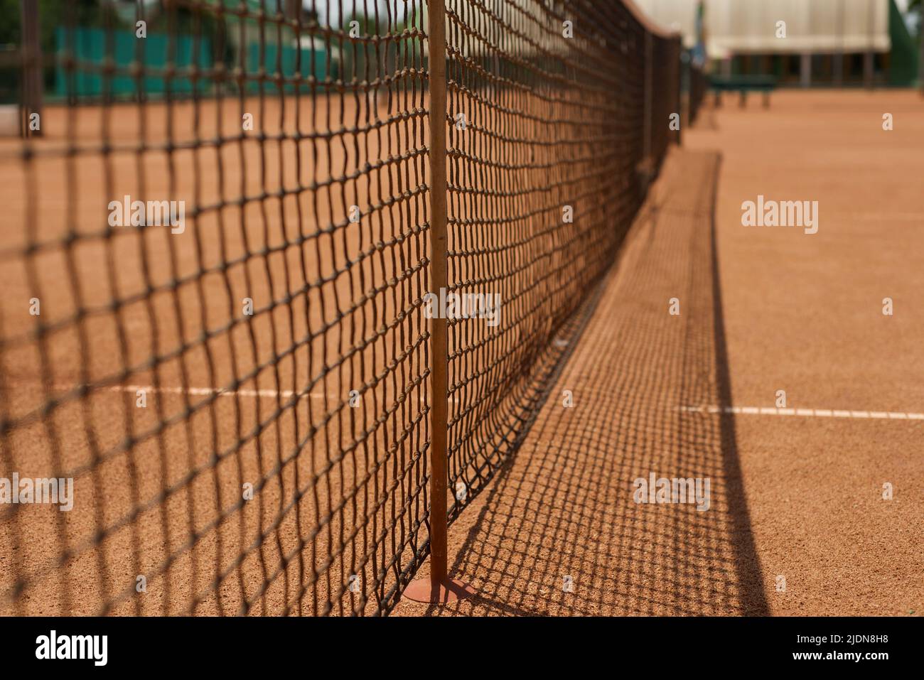 Tennis backgrounds. Tennis net and its shadow on a clay court ...