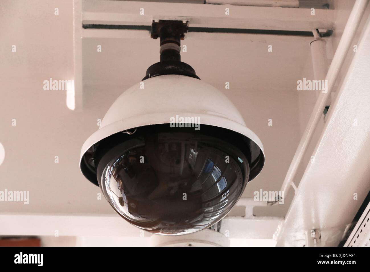Surveillance cameras and a loudspeaker on the bulkhead of the ship's ...