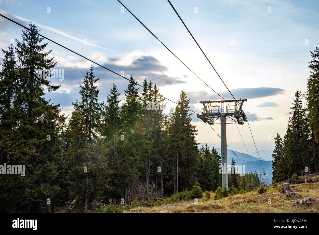 Modern tourist lift with strong reliable metal cable passes between ...