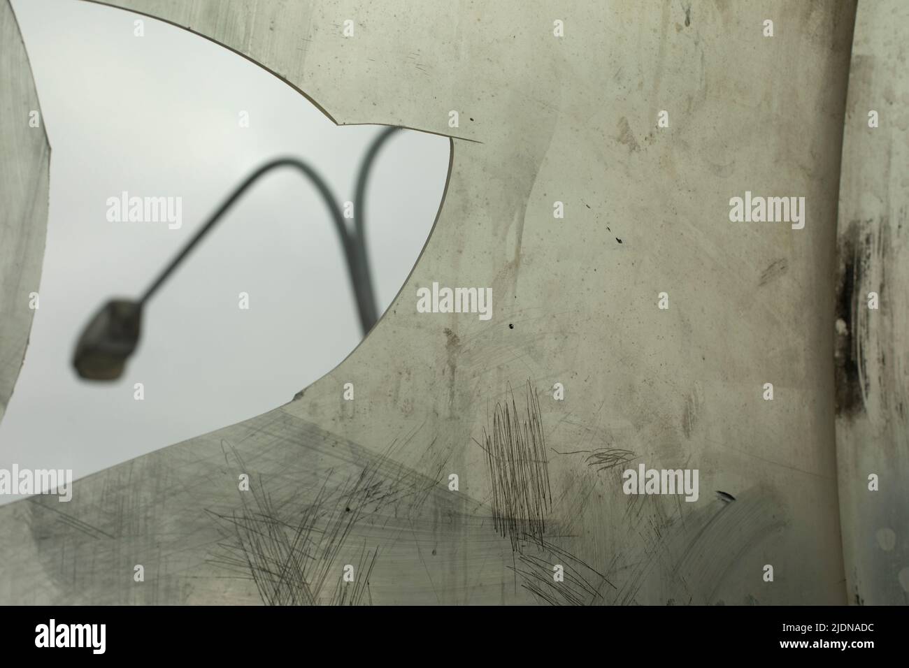 Hole in plastic. Vandalism in city. Broken glass. Broken shard Stock ...