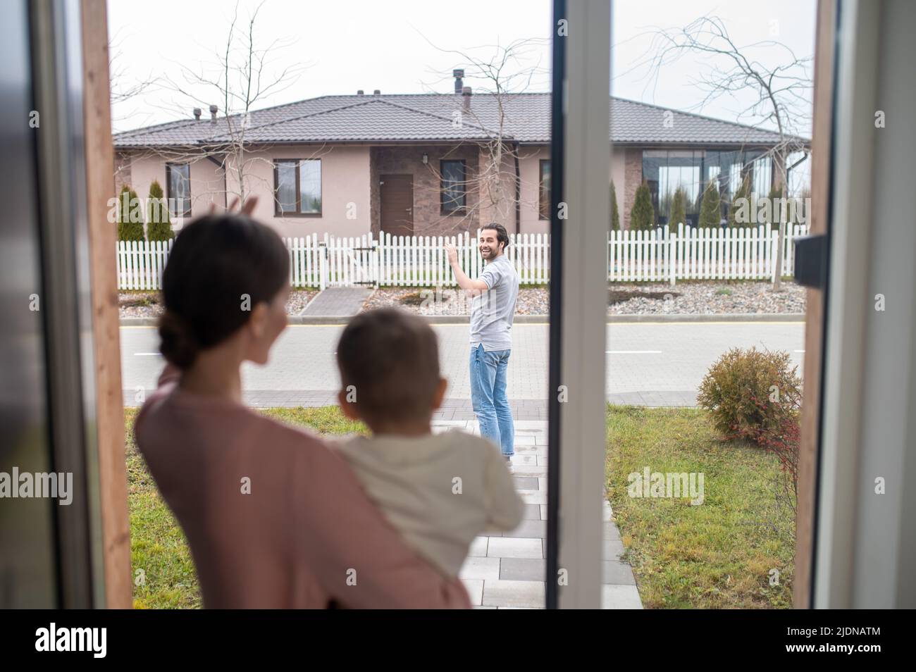 Wife and son waiting for the man coming home from food shopping Stock ...