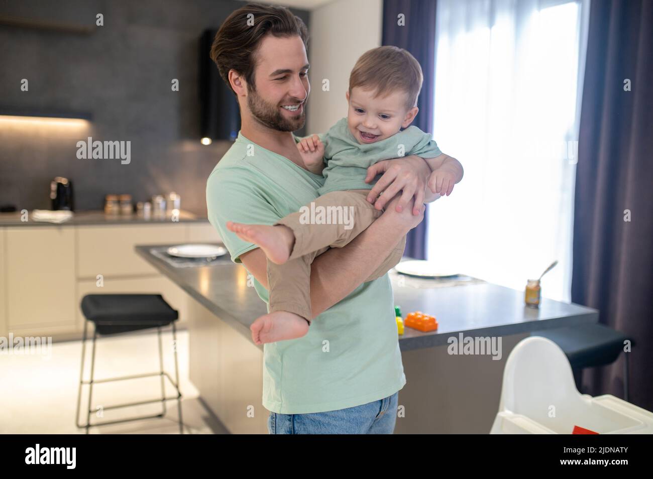 Dad and son looking happy spending time together Stock Photo - Alamy