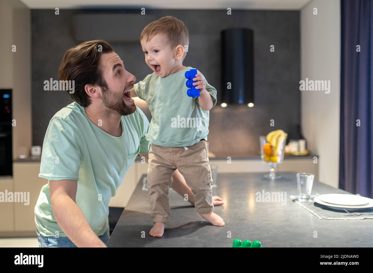 Dad and son looking happy spending time together Stock Photo - Alamy