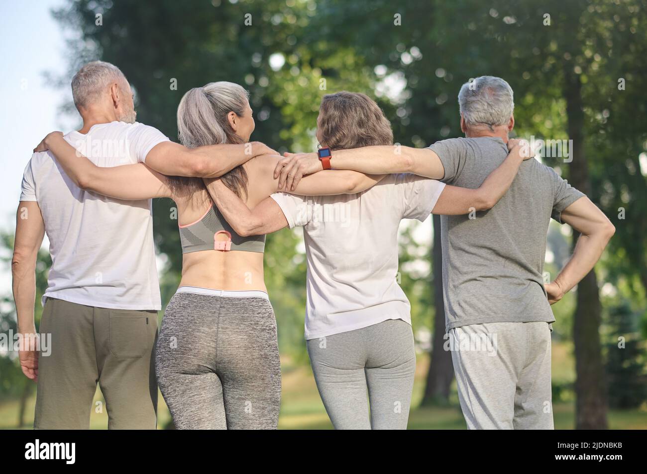 A group of mature people in sportswear feeling great together in the ...