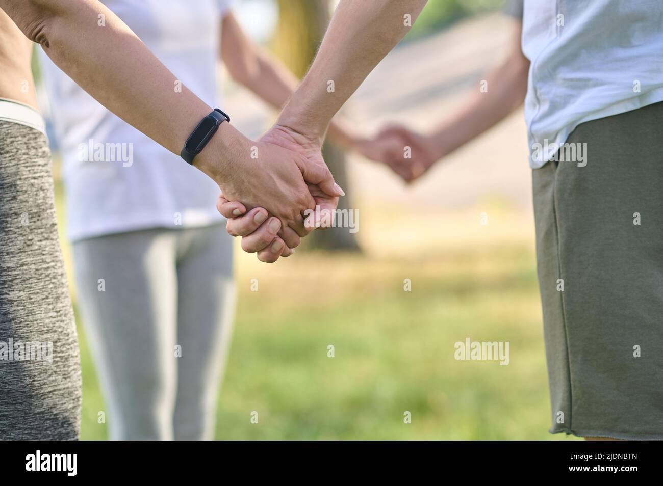 Close up picture of peples hands holding each other Stock Photo - Alamy