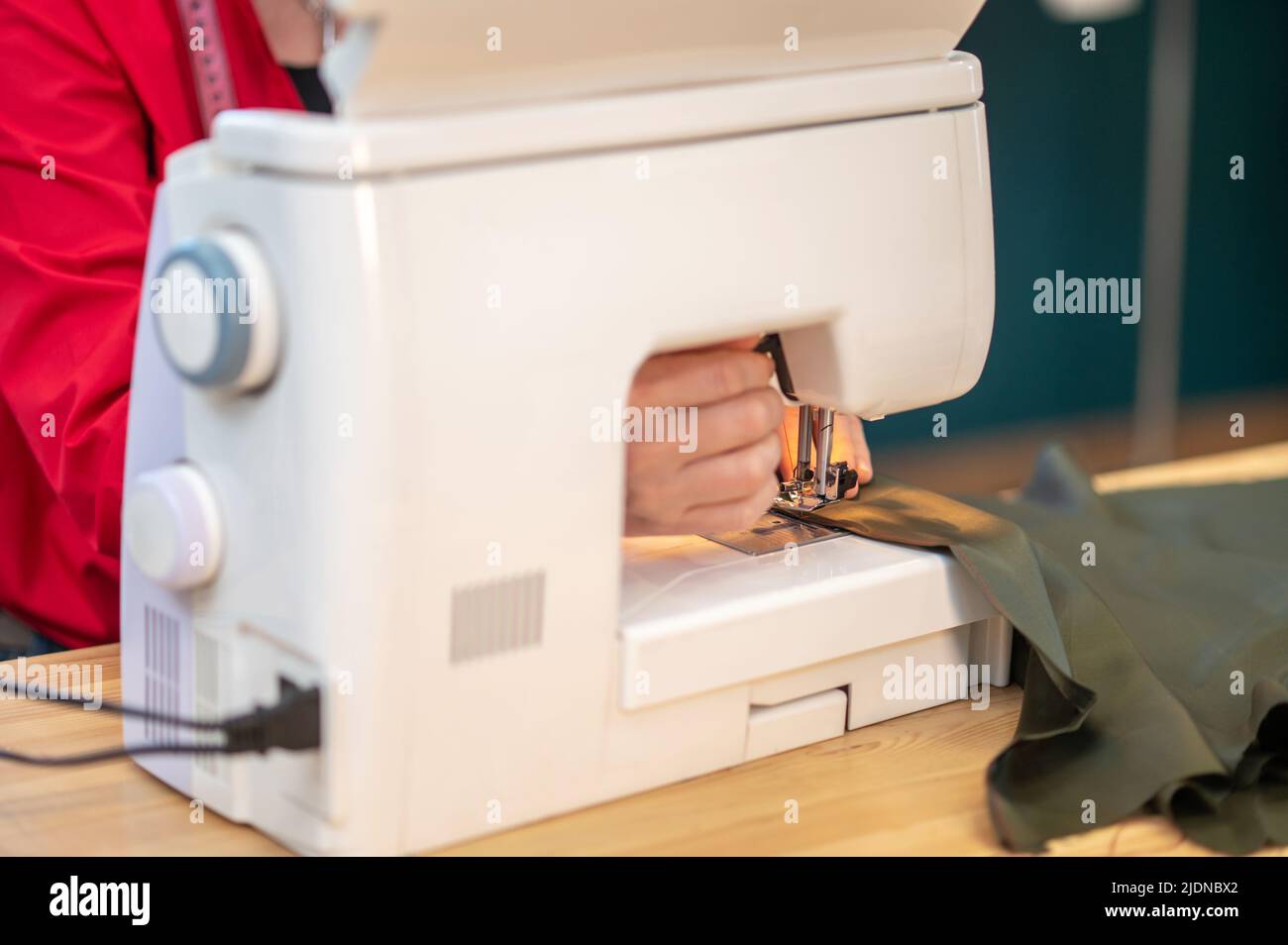 Hands touching fabric and sewing machine Stock Photo - Alamy