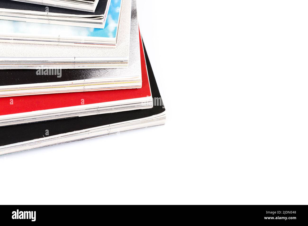 Magazines stack up close shot on white background Stock Photo - Alamy