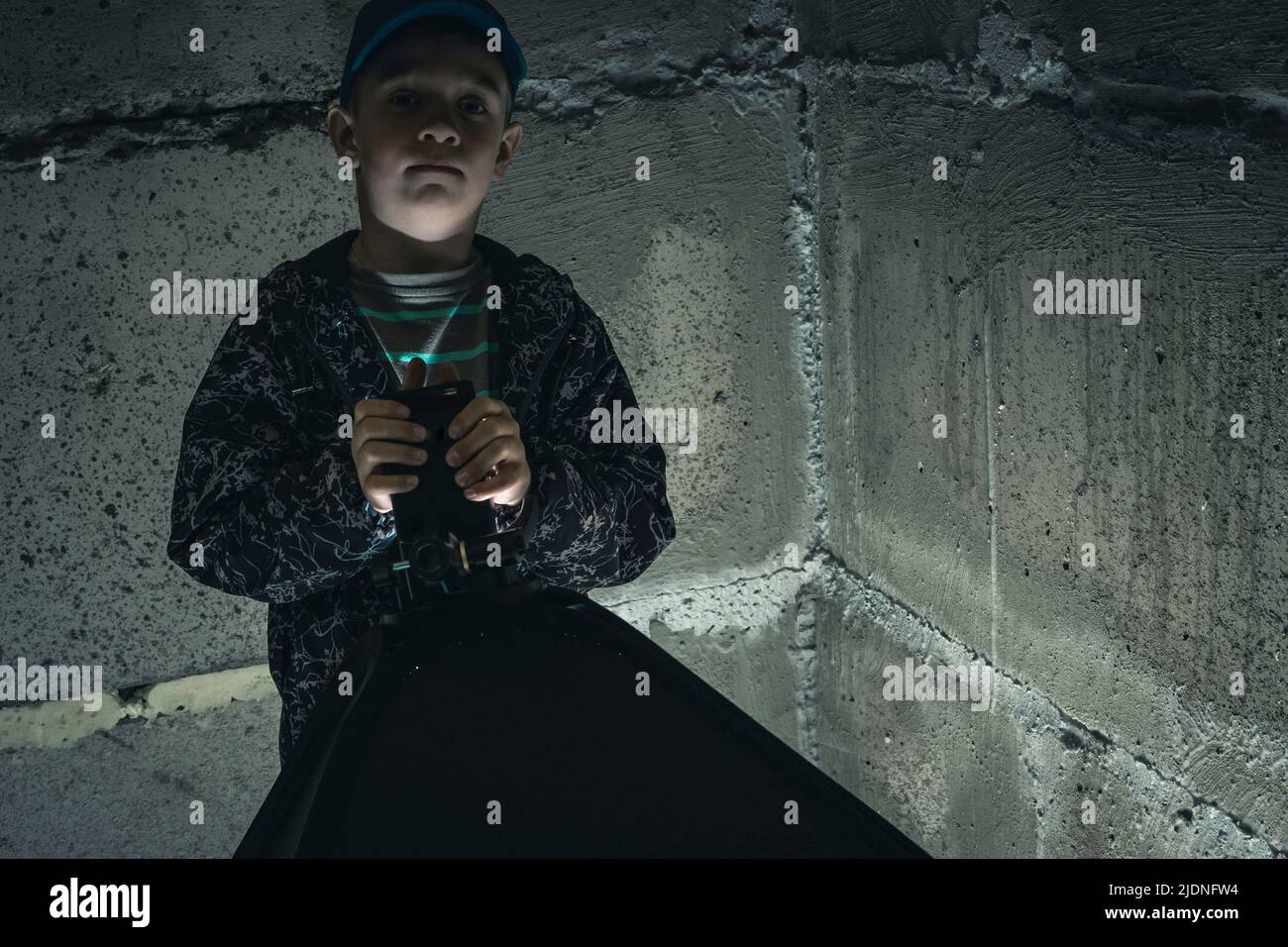 caucasian preschool boy in a dark concrete basement Stock Photo - Alamy