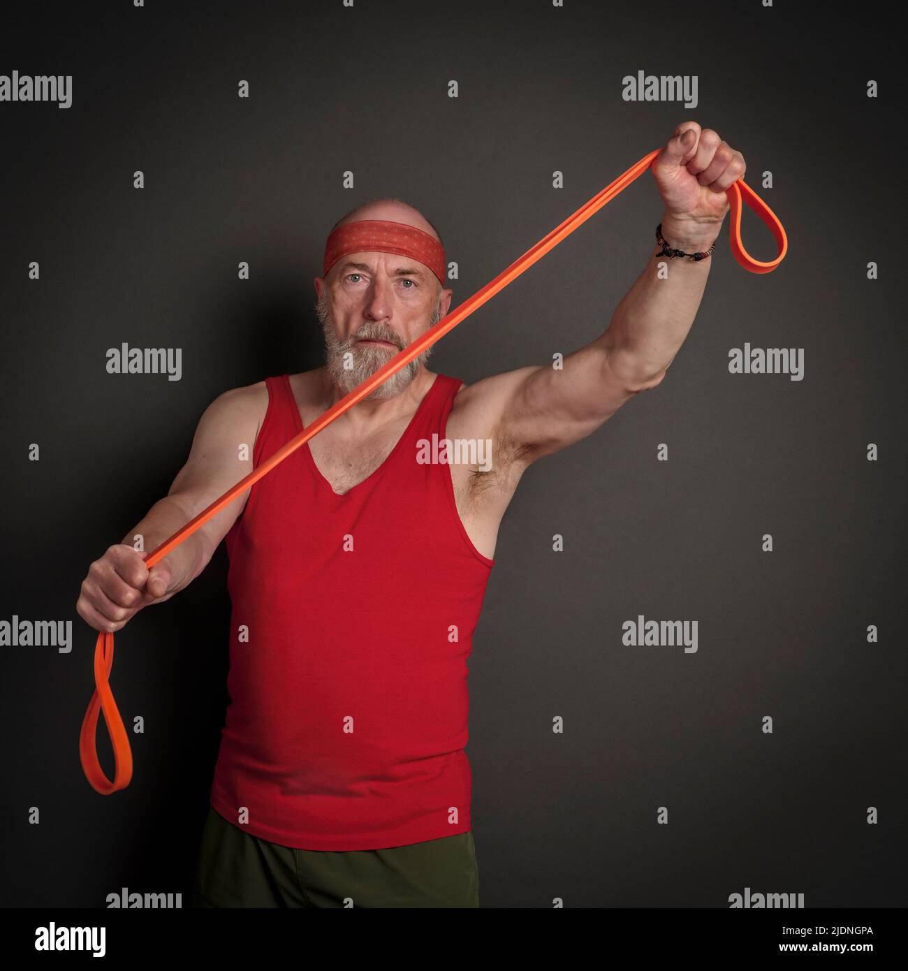 head and shoulder portrait of senior man (in late 60s) exercising with ...
