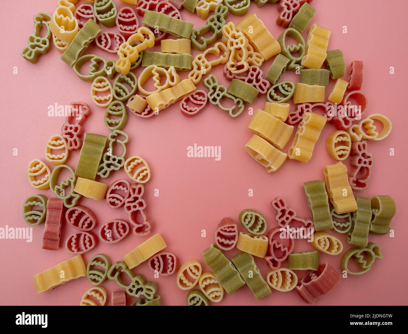 Raw pasta. Vermicelli in different colors. Pasta on a pink background ...