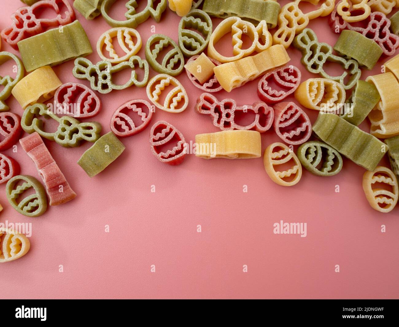 Raw pasta. Vermicelli in different colors. Pasta on a pink background ...