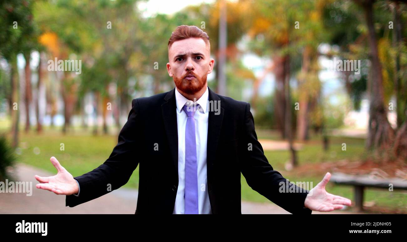 Angry business man standing arguing to camera outside. Upset executive ...