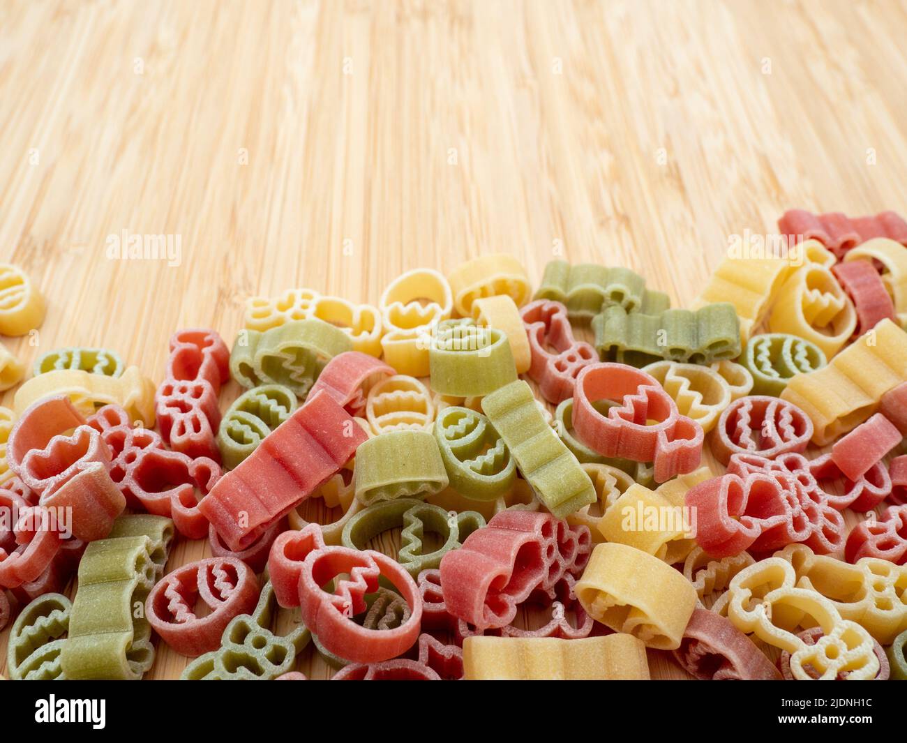 Raw pasta. Vermicelli in different colors. Pasta on a wooden background ...