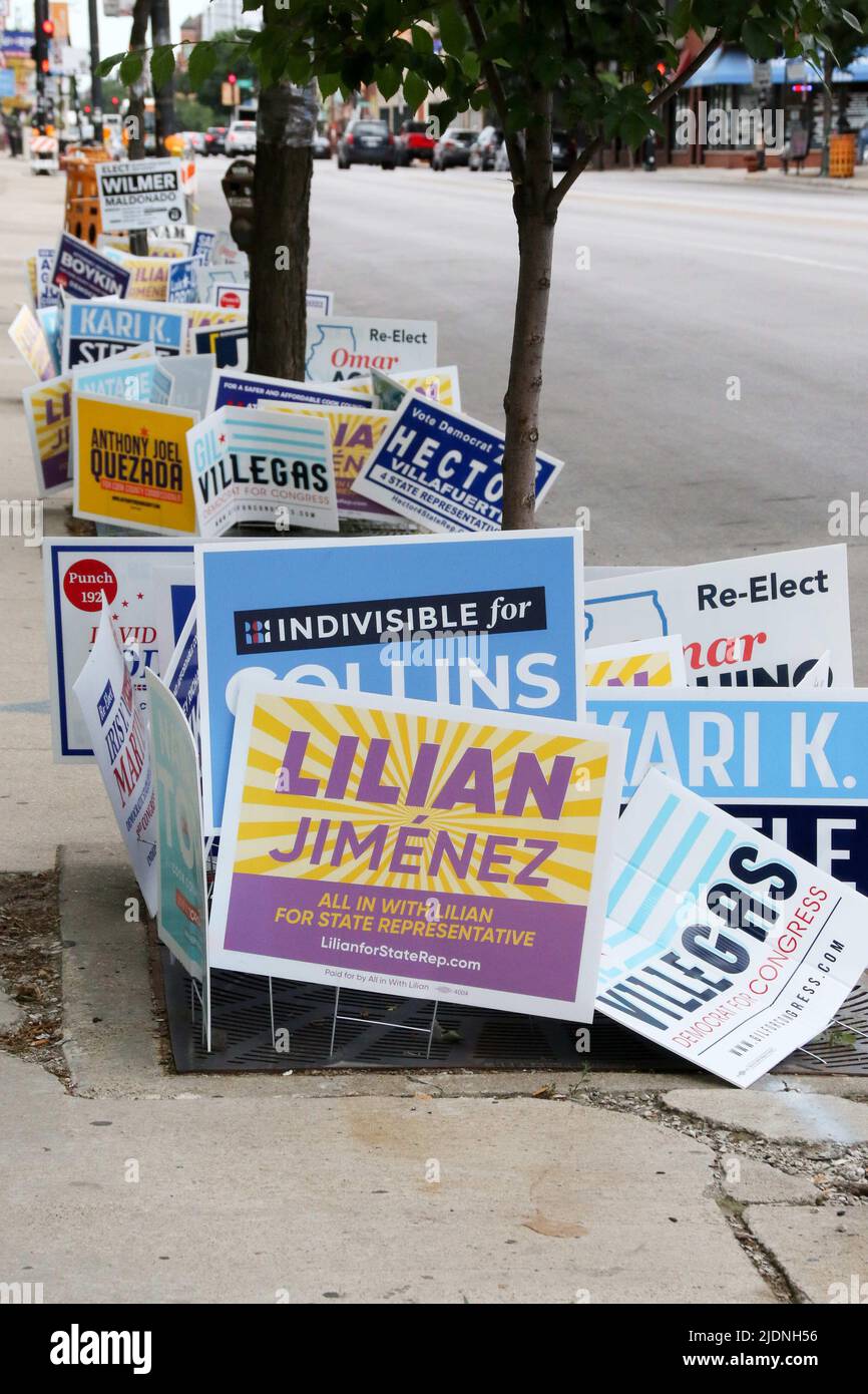 Campaign signs crowd the sidewalk in front of a polling station at the ...