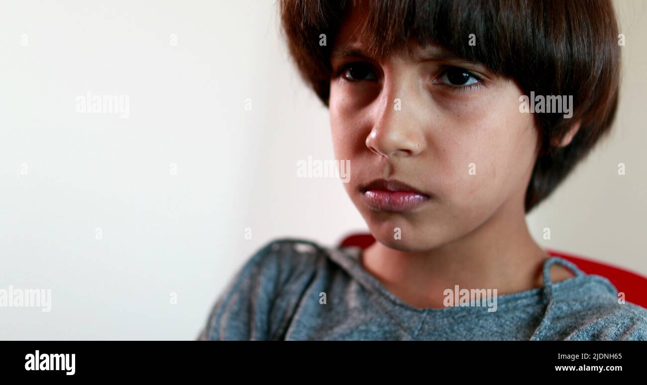 Angry child reaction crossing arms in anger. Offended young boy with ...