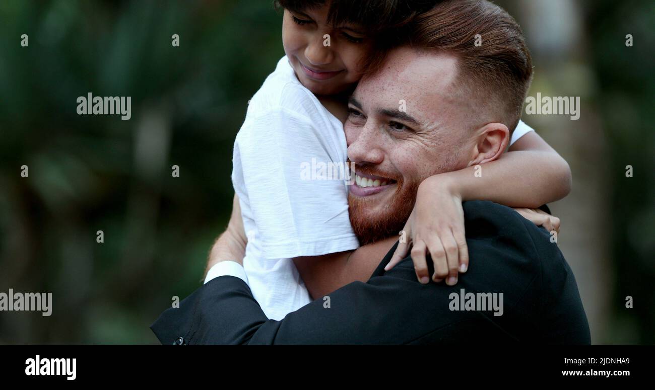 Beautiful child and father embrace, mixed race son hugging dad ...