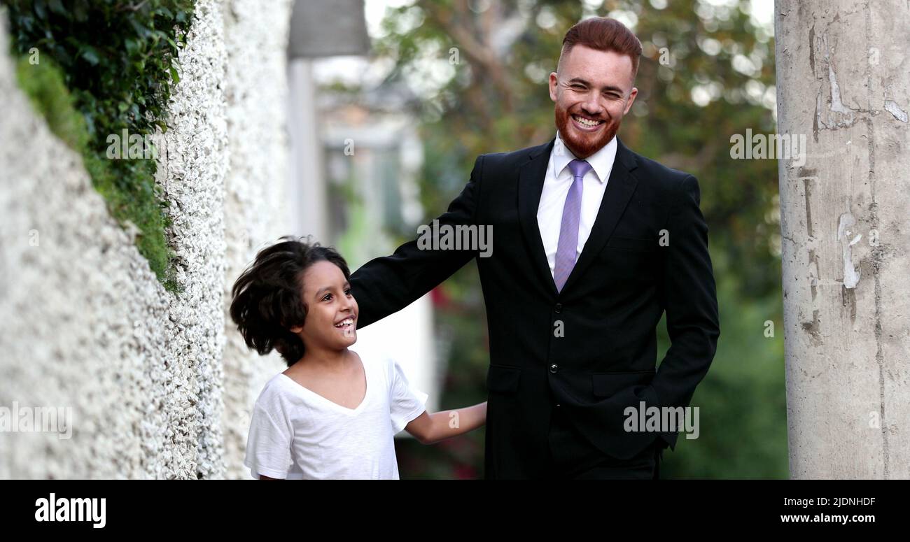 Beautiful father and mixed race son walking together in urban city ...