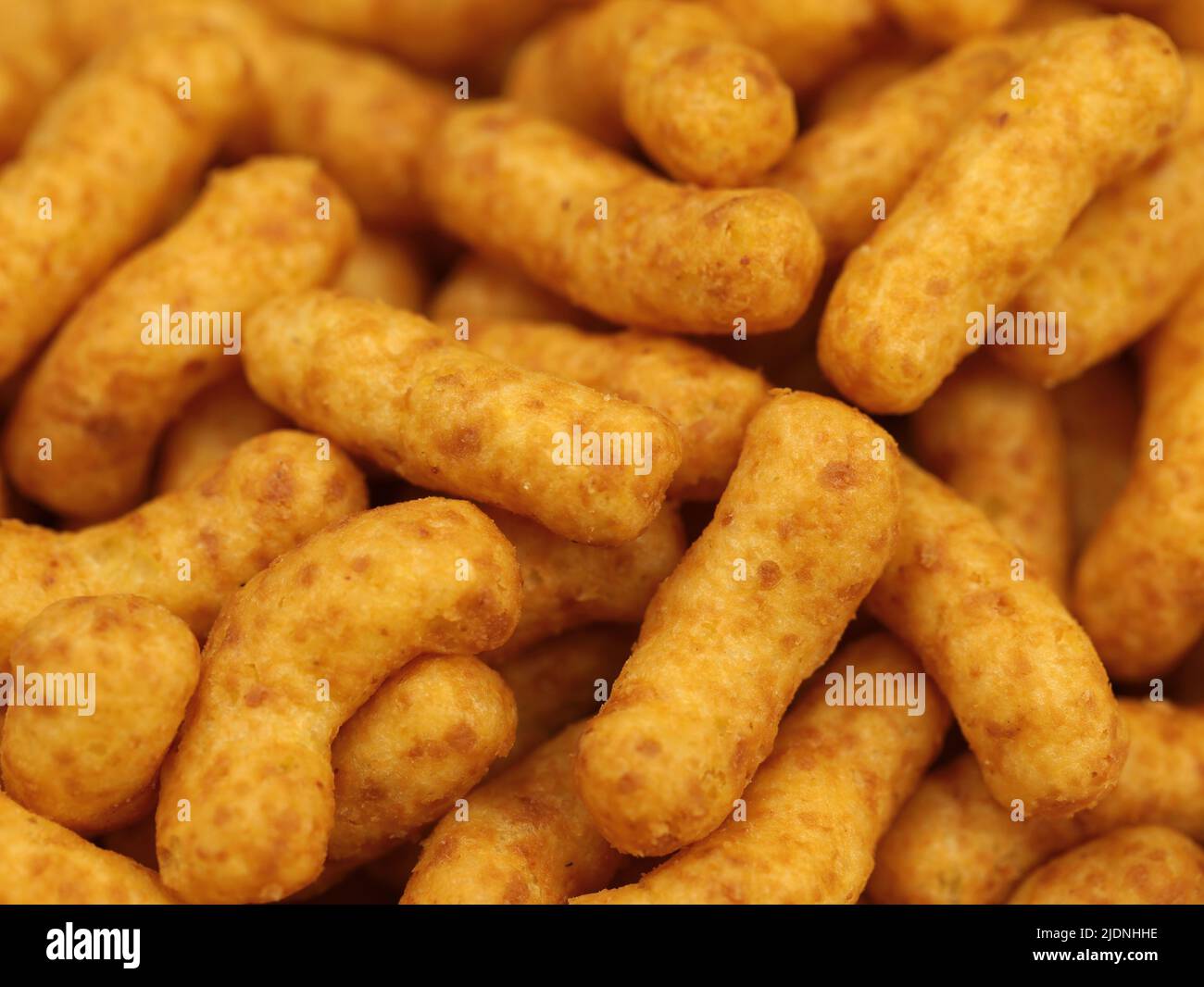 Peanut flips close up, corn puffs snack background Stock Photo - Alamy