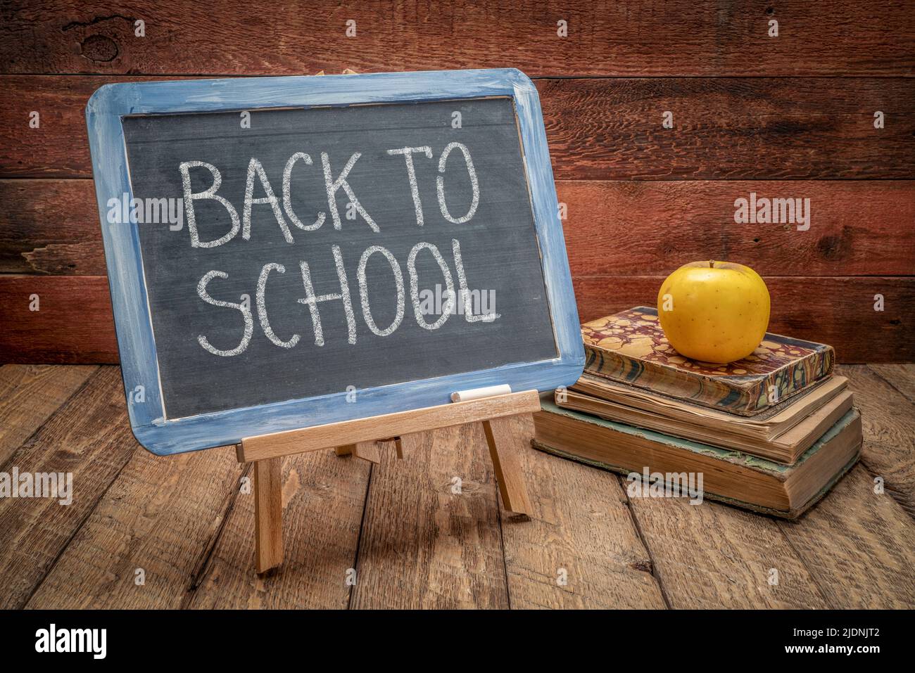 back to school - white chalk writing on a slate blackboard in a retro ...