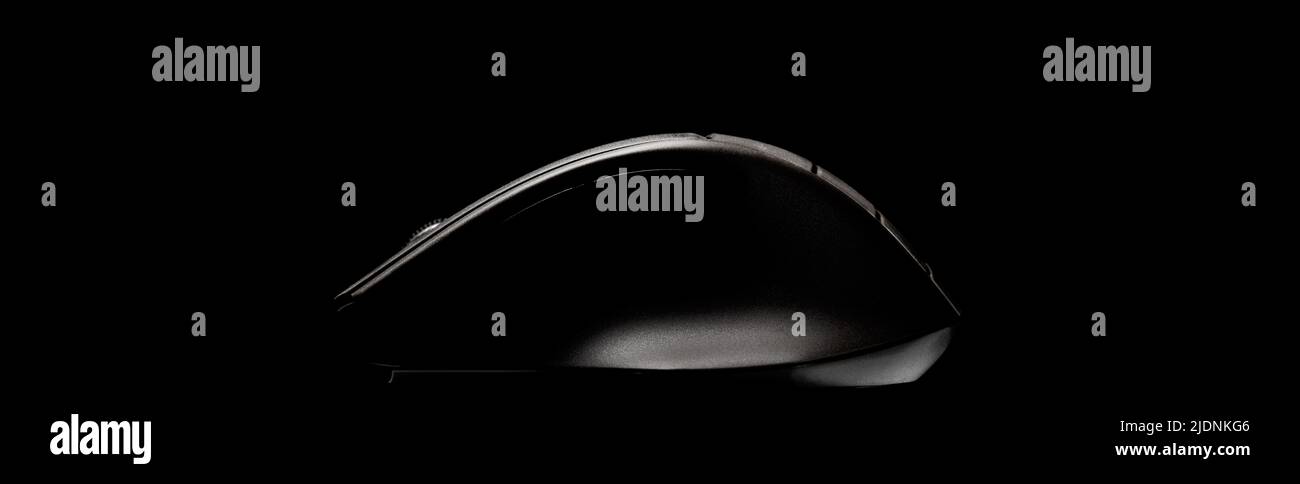 Black computer mouse on a black background.Mouse for PC filmed on a ...
