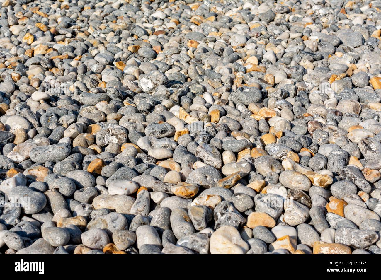 Pebbles on the beach, in the sun Stock Photo - Alamy