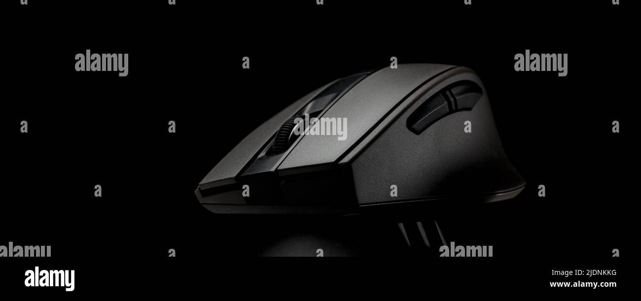 Black computer mouse on a black background.Mouse for PC filmed on a ...