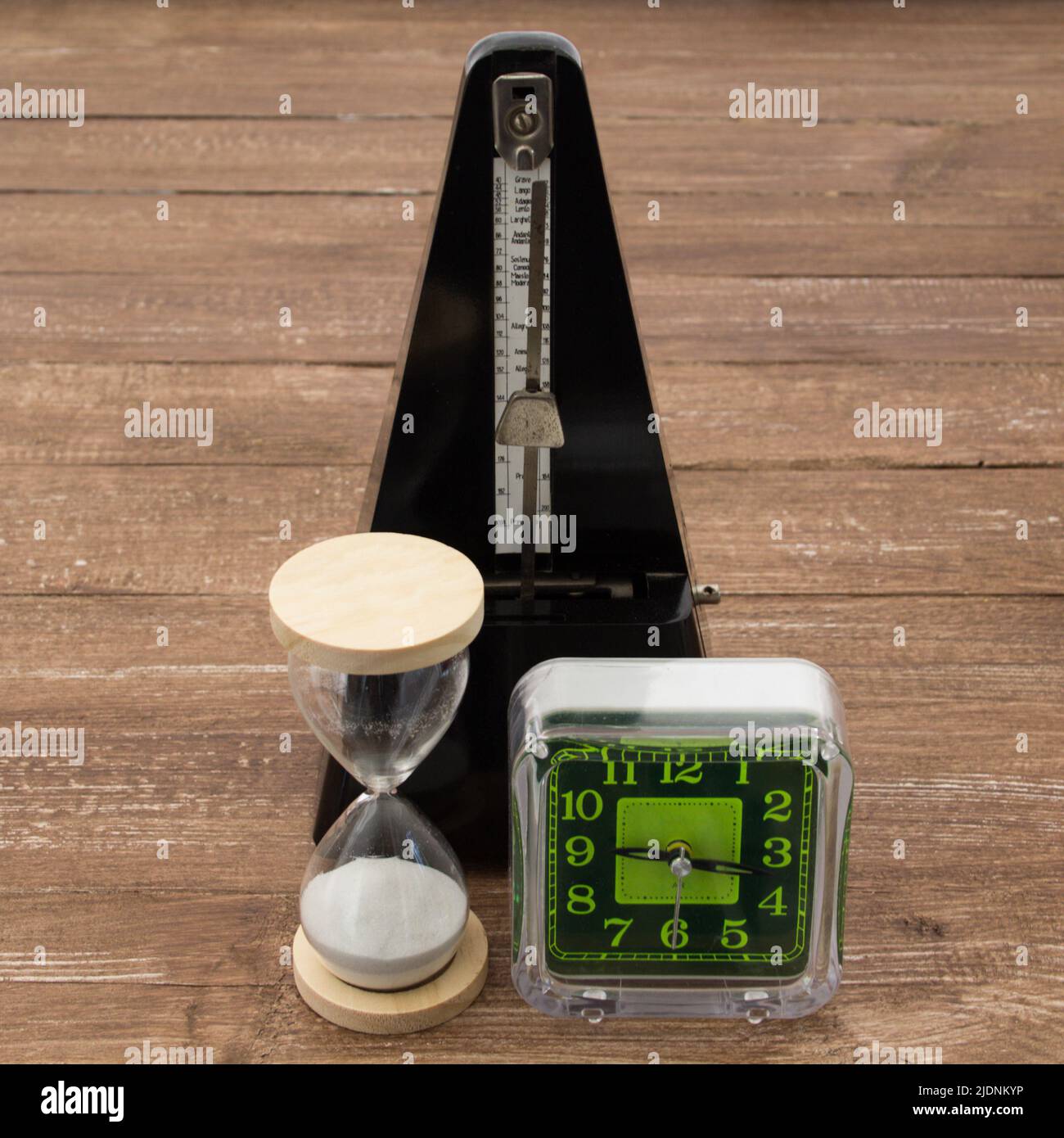 Image of a table clock an hourglass and a metronome, representation of ...