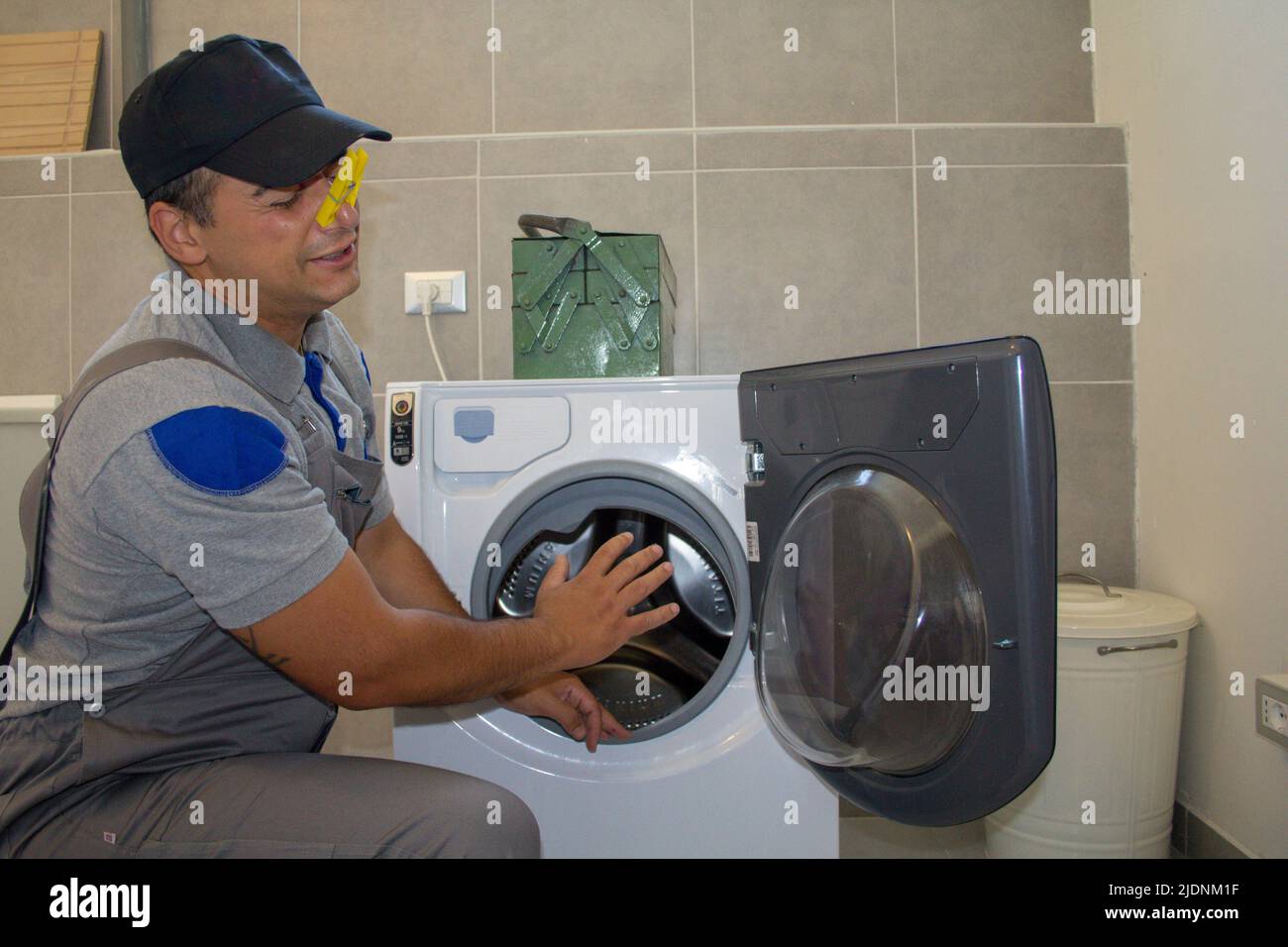 Image of a technician with a clothespin in his nose trying to fix a ...