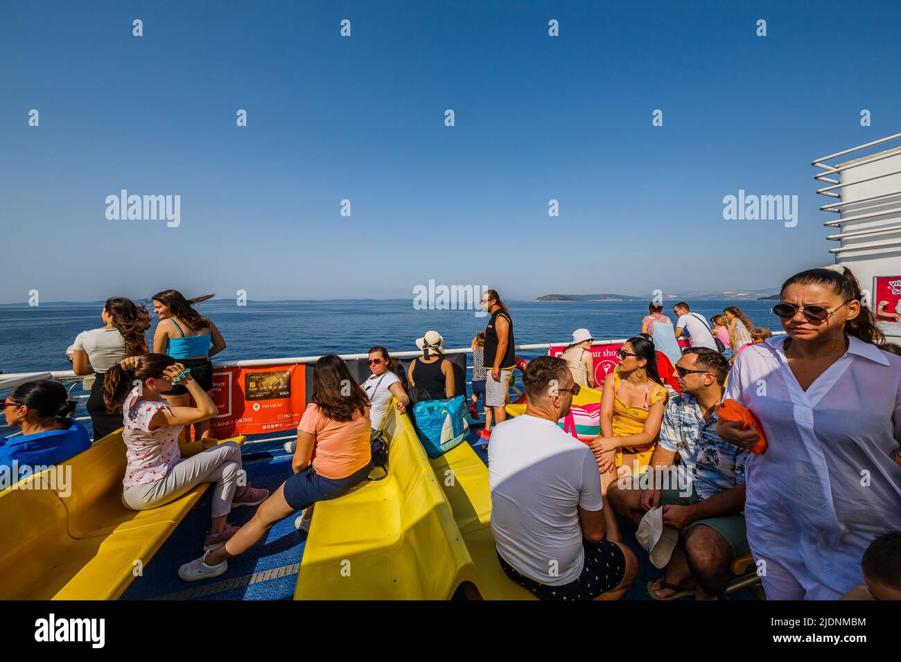 Tourists are seen on a ferry from Split to Supetar on the island of ...