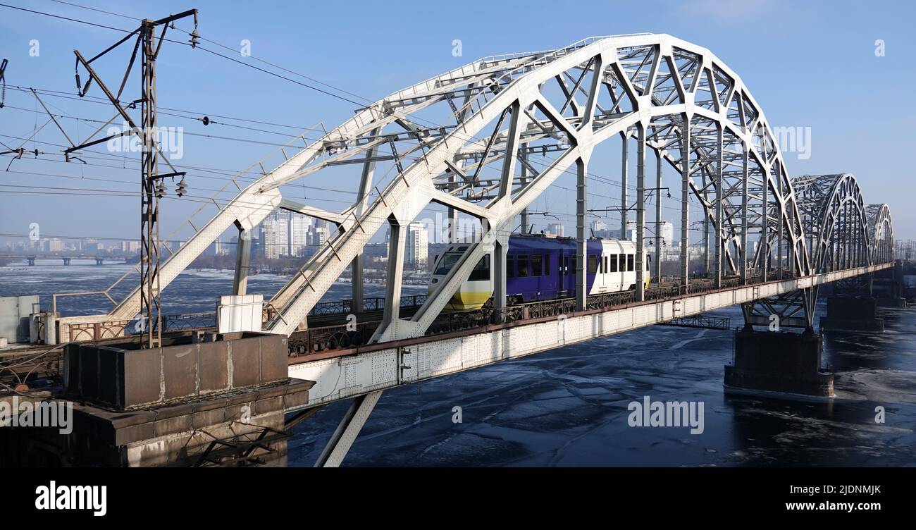 Kiev, Ukraine January 23, 2021: A train rides across the Railway Bridge ...