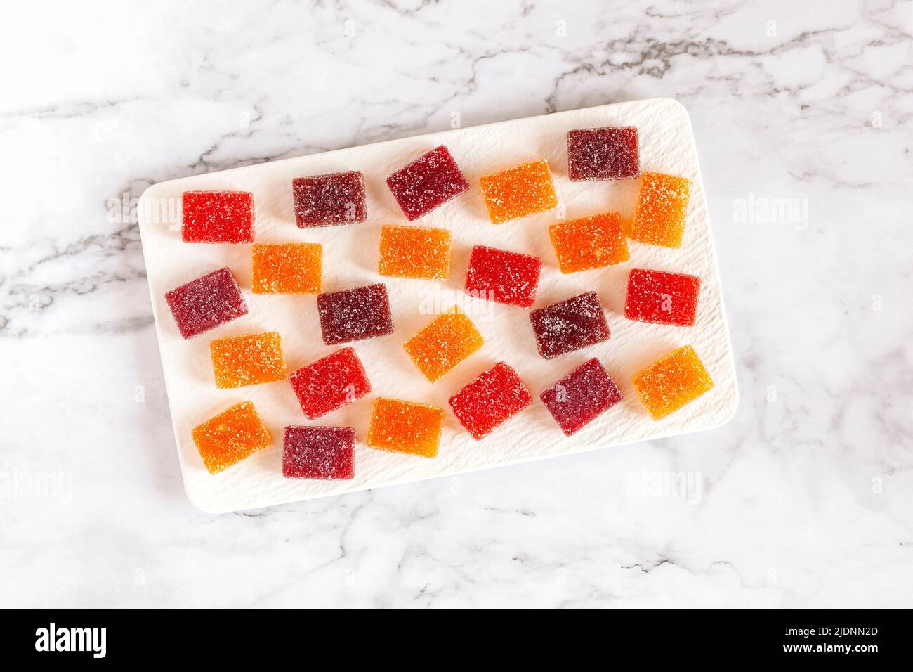 Fruit paste on a square plate on marble background Stock Photo - Alamy