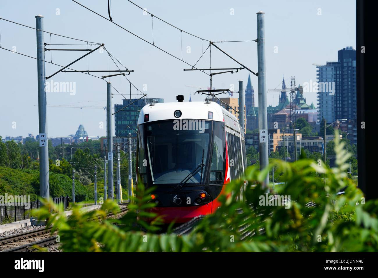 An Ottawa Light Rail Transit (OLRT) train travels along the tracks in ...