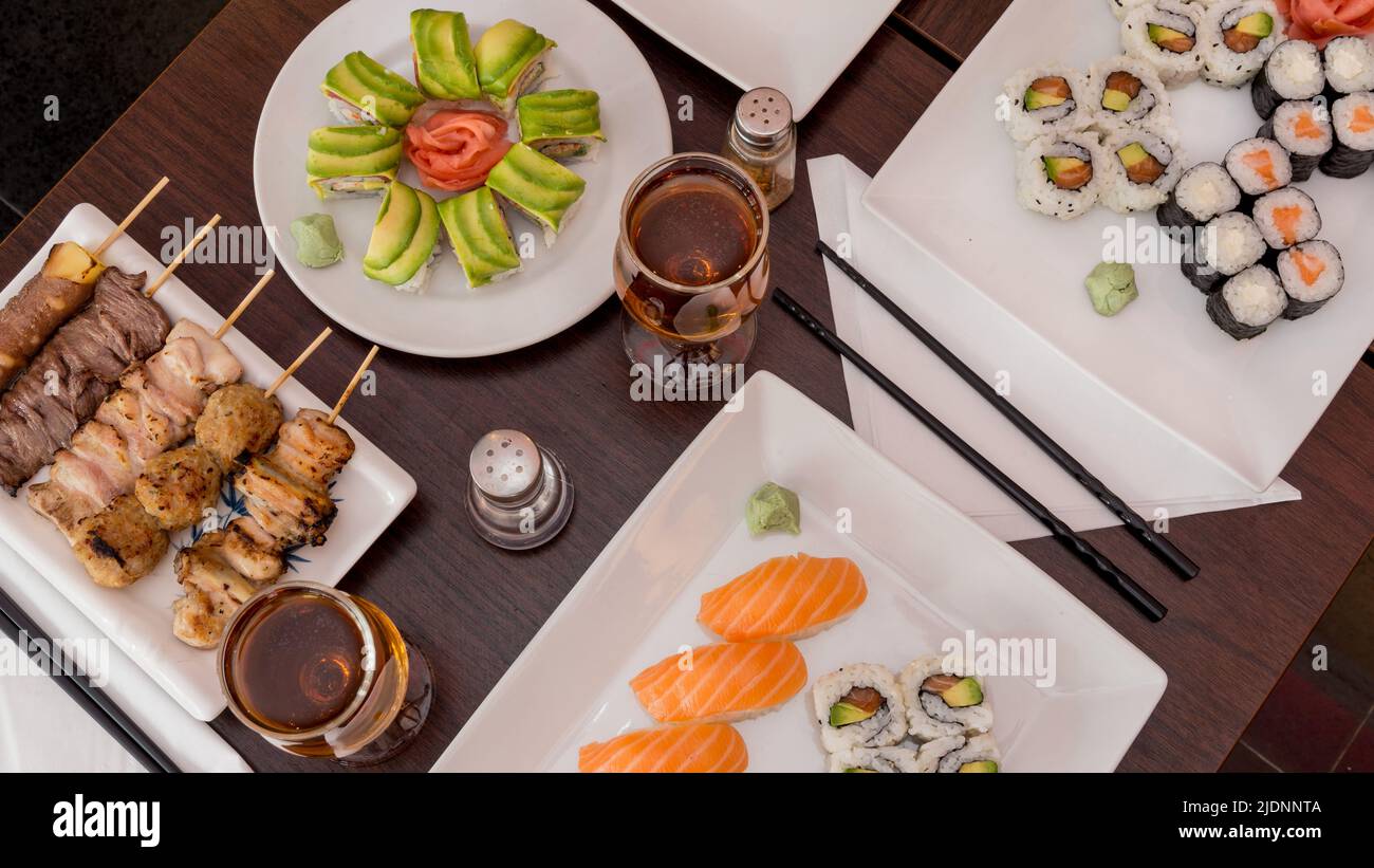 Plates of sushi on a table in a Japanese restaurant Stock Photo - Alamy