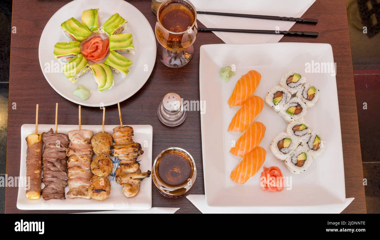 Plates of sushi on a table in a Japanese restaurant Stock Photo - Alamy