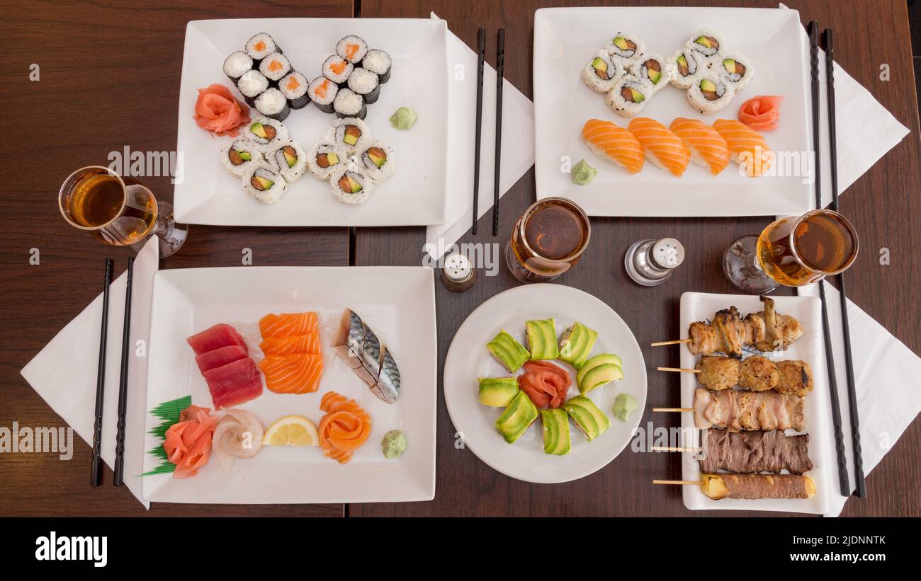 Plates of sushi on a table in a Japanese restaurant Stock Photo - Alamy