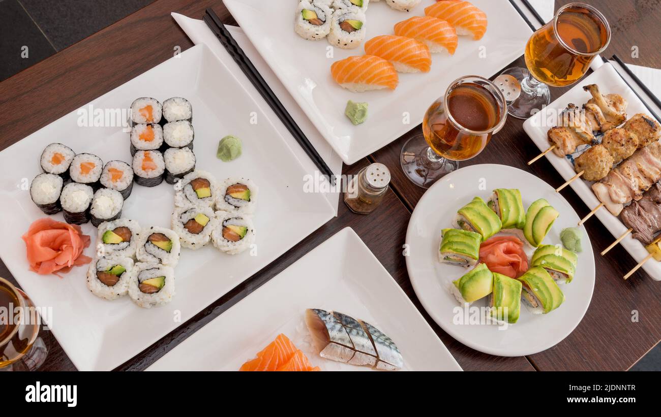 Plates of sushi on a table in a Japanese restaurant Stock Photo - Alamy