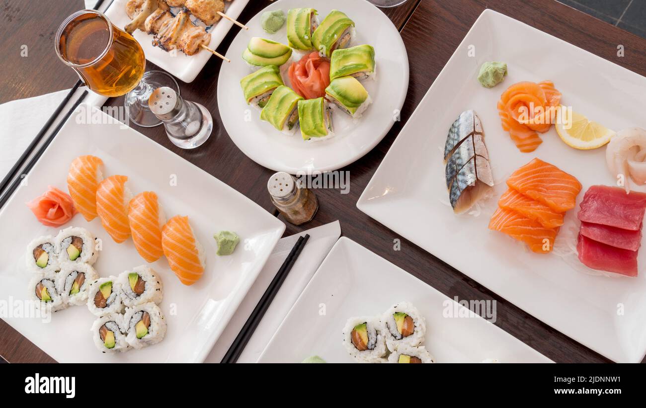 Plates of sushi on a table in a Japanese restaurant Stock Photo - Alamy