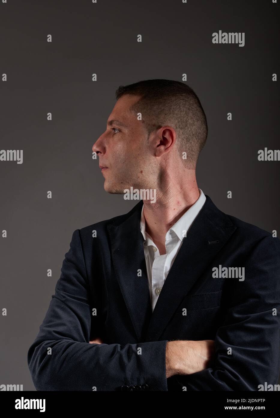 A young, elegant man dressed in a white shirt and black jacket Stock ...