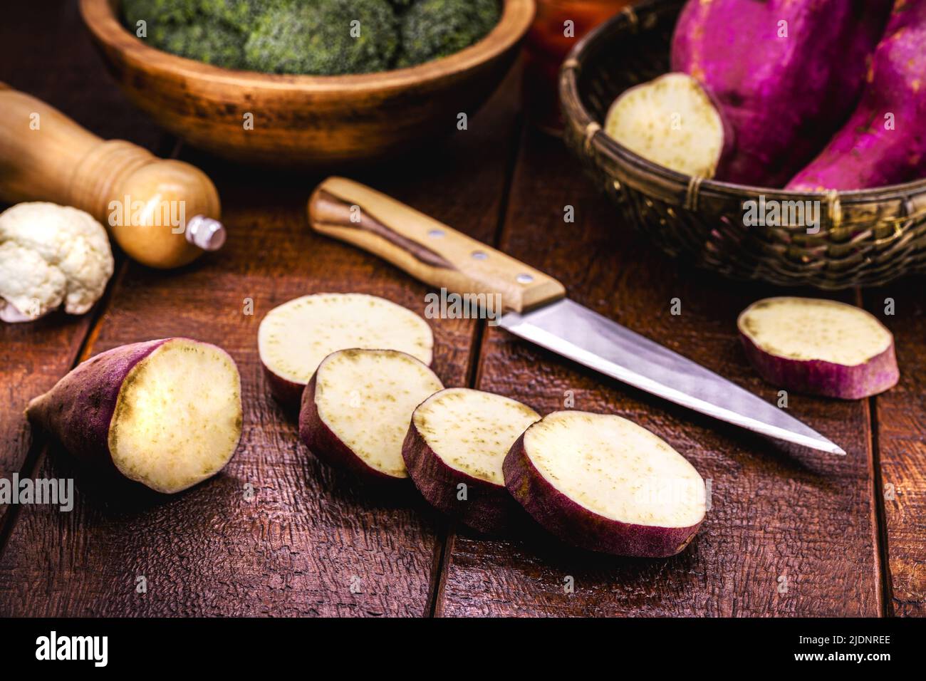 sliced sweet potato on rustic wooden table, tuber called earth potato ...