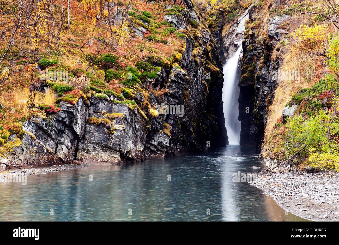A waterfall deep into a canyon, ponds this side. Autumn colors in the ...