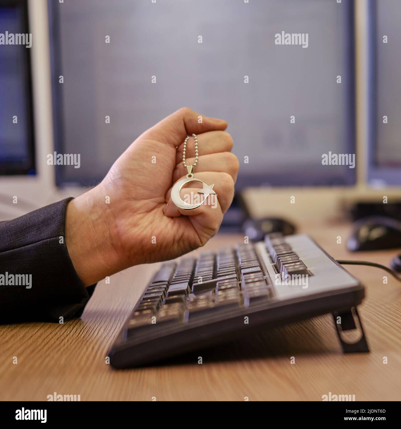 A businessman man with a religious Muslim symbol in his hands is ...