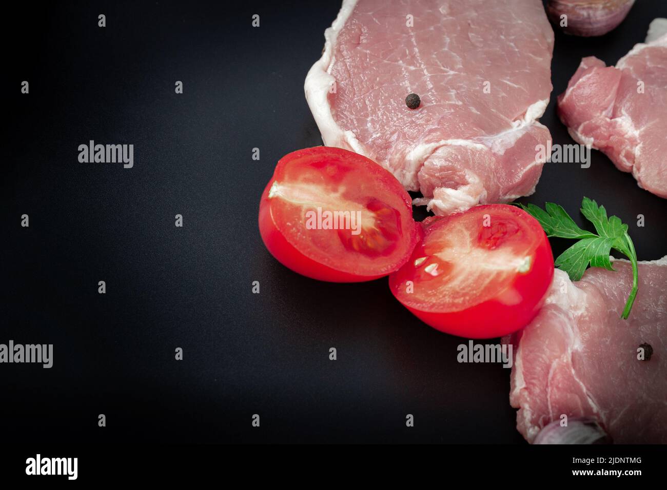 Raw pork chops of meat with tomato. Fillet steak beef meat Stock Photo ...