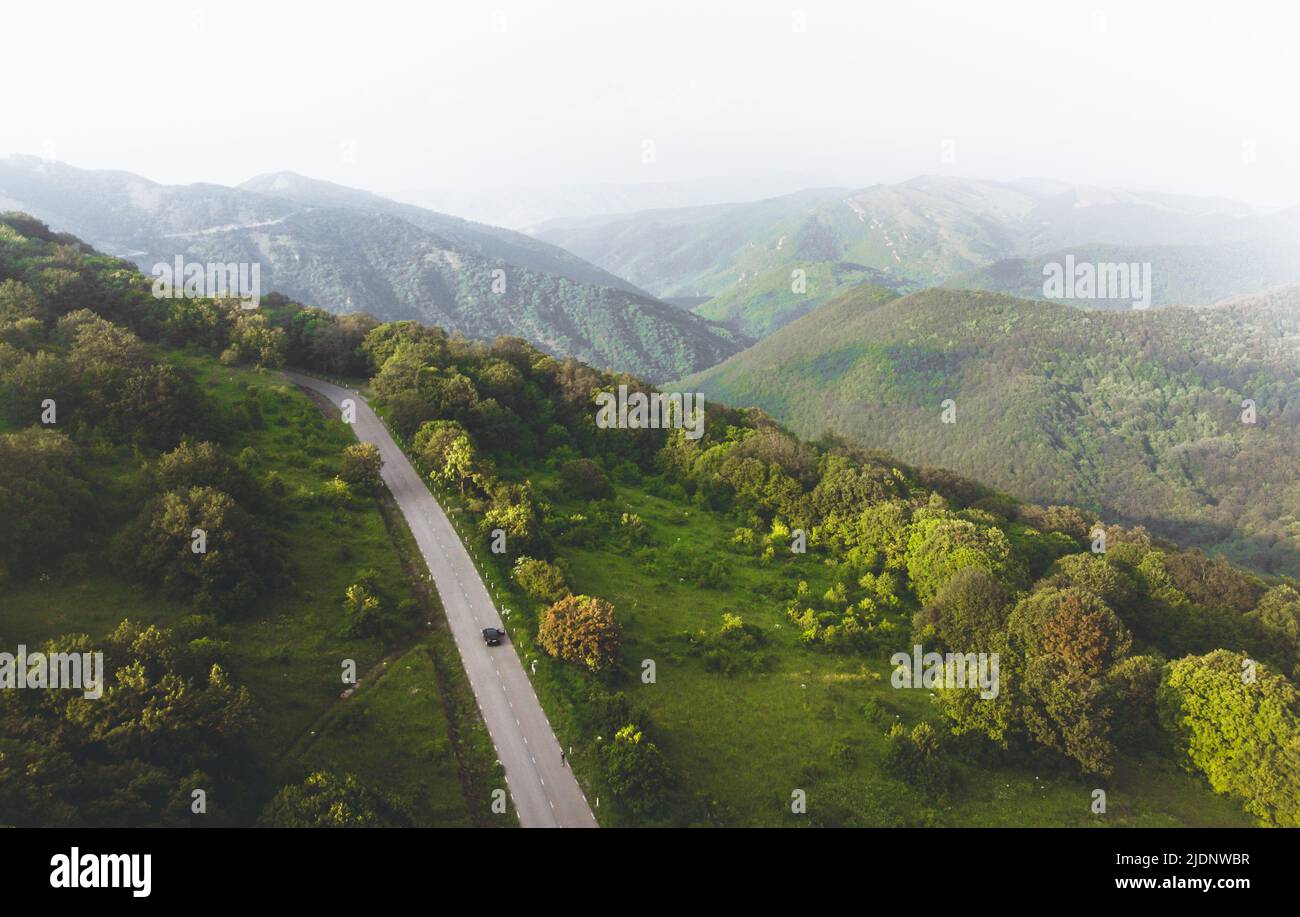 Aerial birds eye view of car on asphalt road in scenic caucasian ...