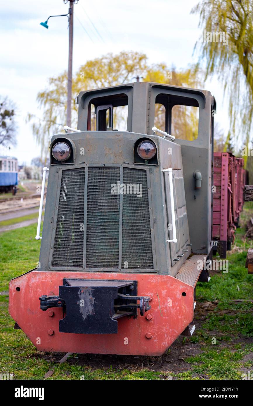 An old, narrow track diesel locomotive standing at the museum's train ...