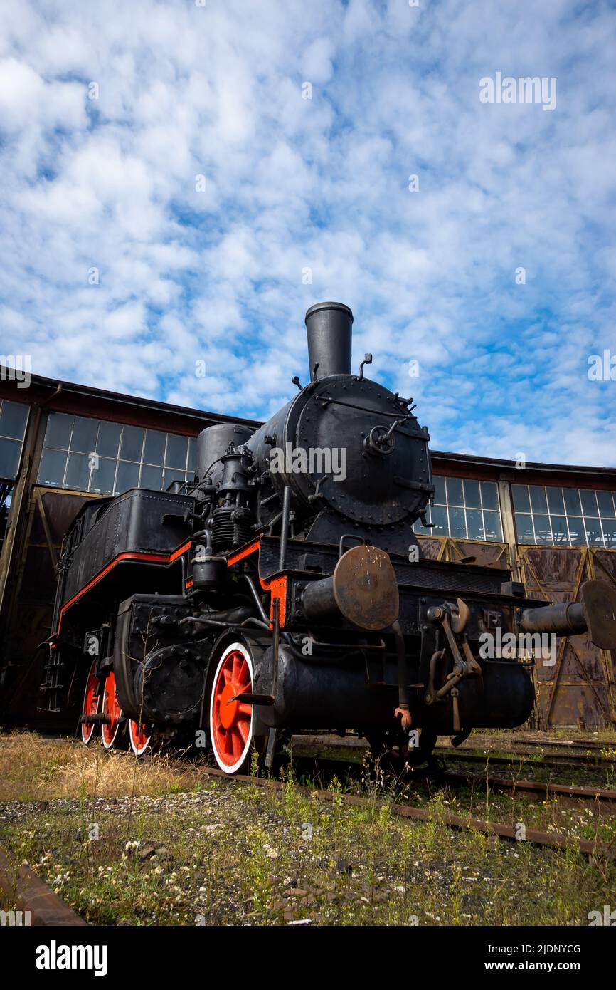 A steam locomotive standing outside of historic locomotive shed. The ...