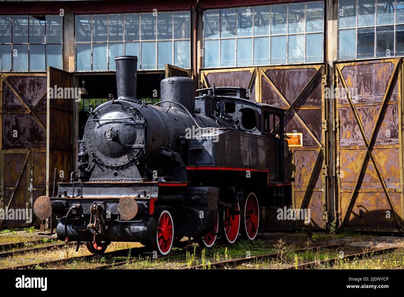 A steam locomotive standing outside of historic locomotive shed. The ...